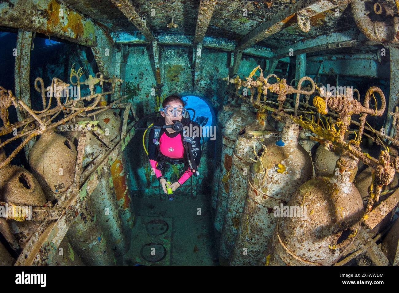 Diver swimming through wreck, compressor room of USS Kittiwake, US ...
