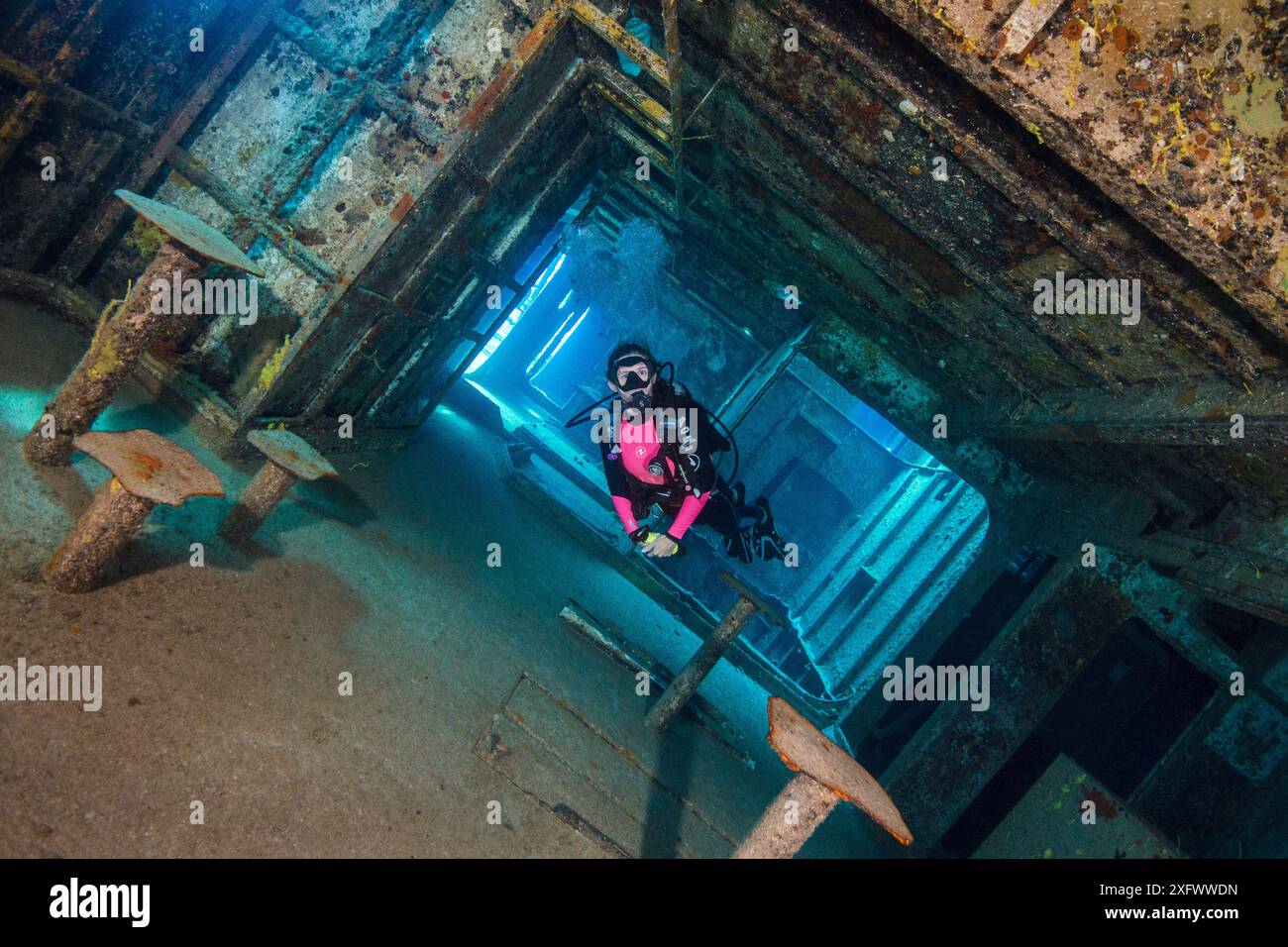 Diver swimming through wreck, mess hall of USS Kittiwake, US Military ...