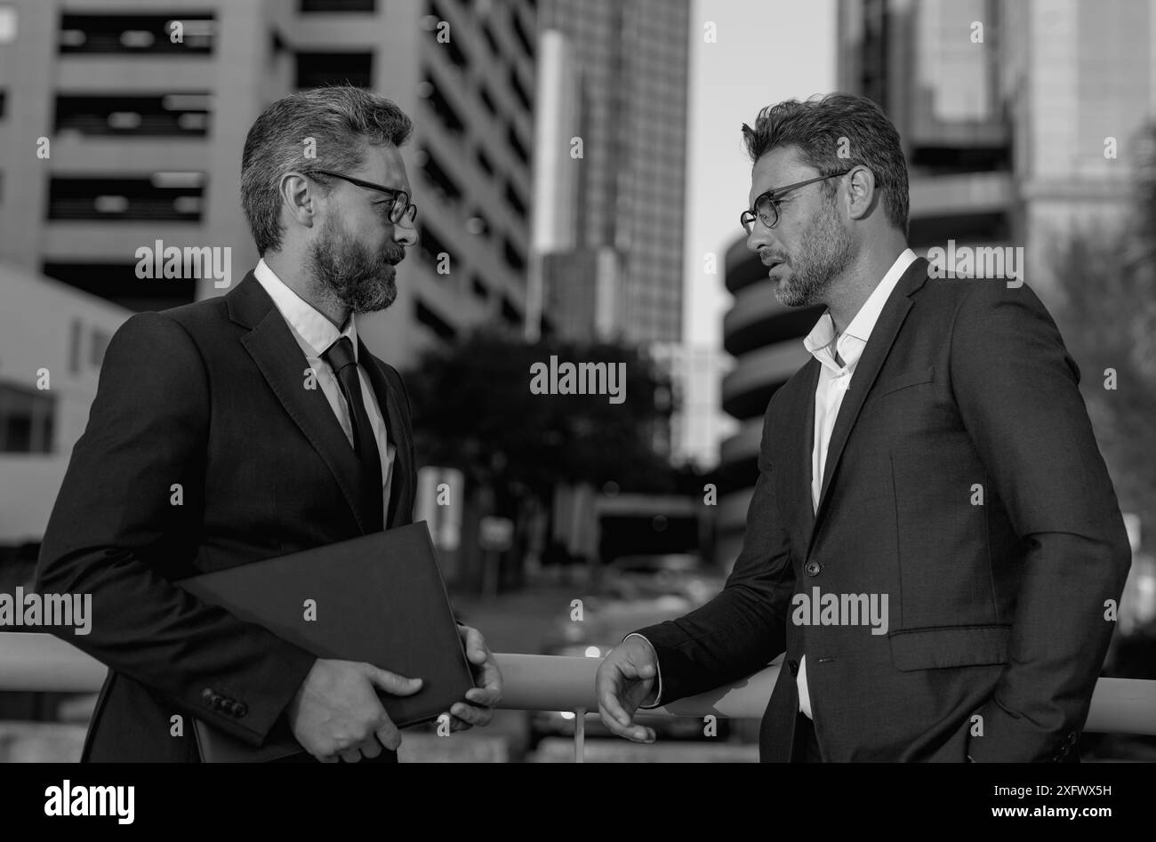 Man standing discussing in Black and White Stock Photos & Images - Alamy