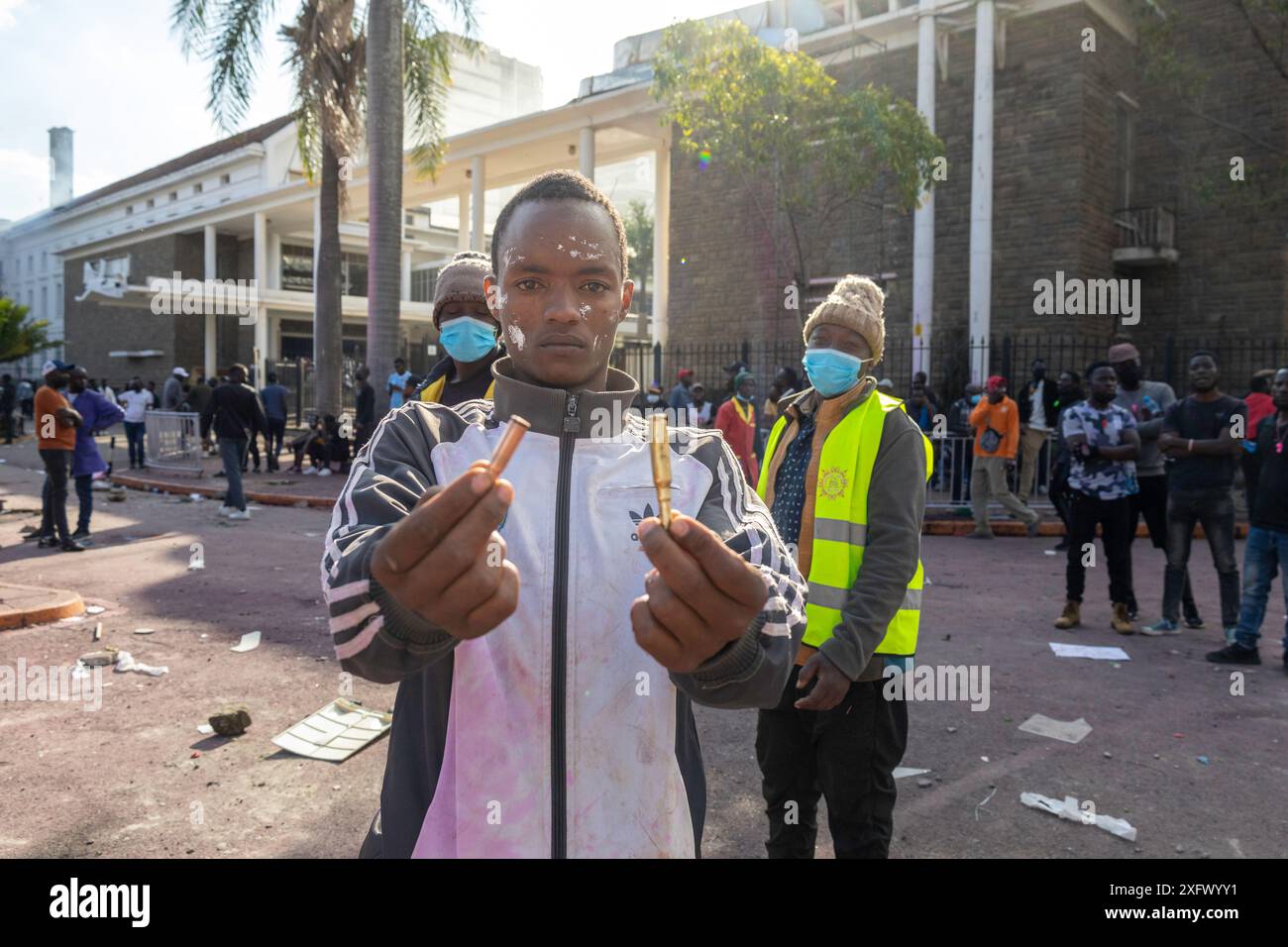 Nairobi, Kenya - June 25th, 2024. A protester holds up rifle shell ...