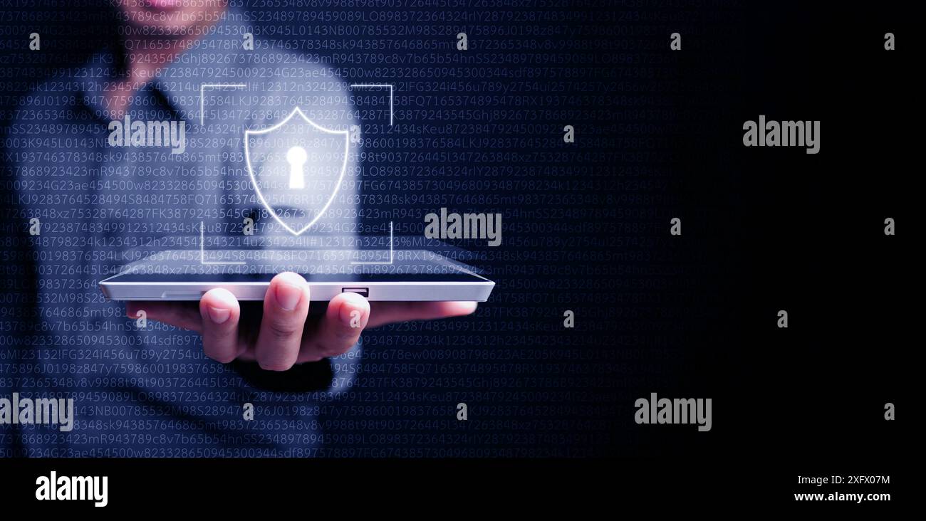 Cyber security data protection. The man uses a virtual digital shield on his tablet computer to ...