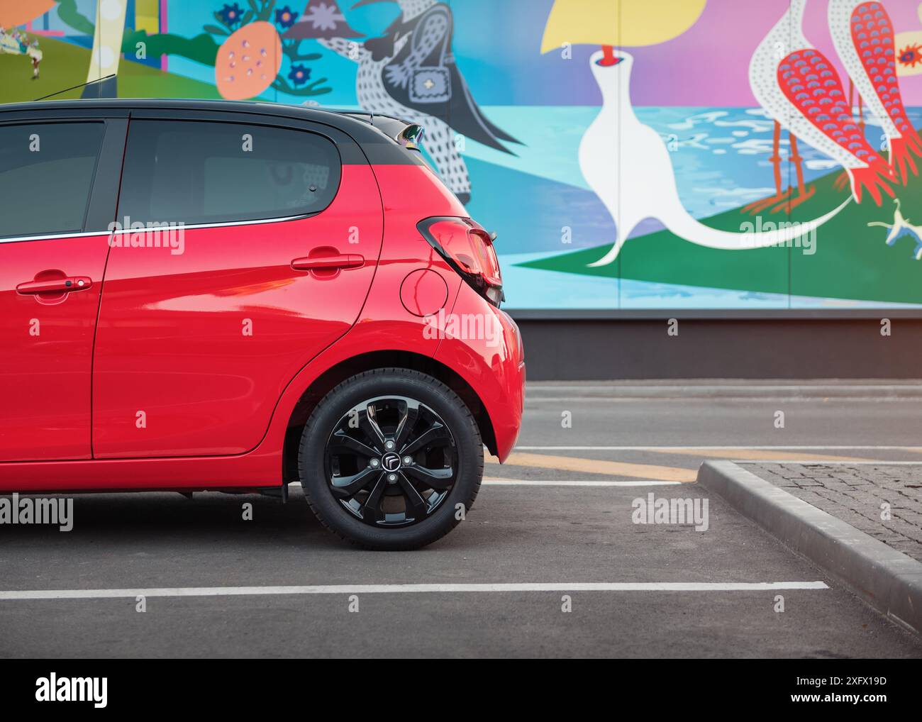 Close up side view of red Citroen C1: rear bumper and tail light in ...