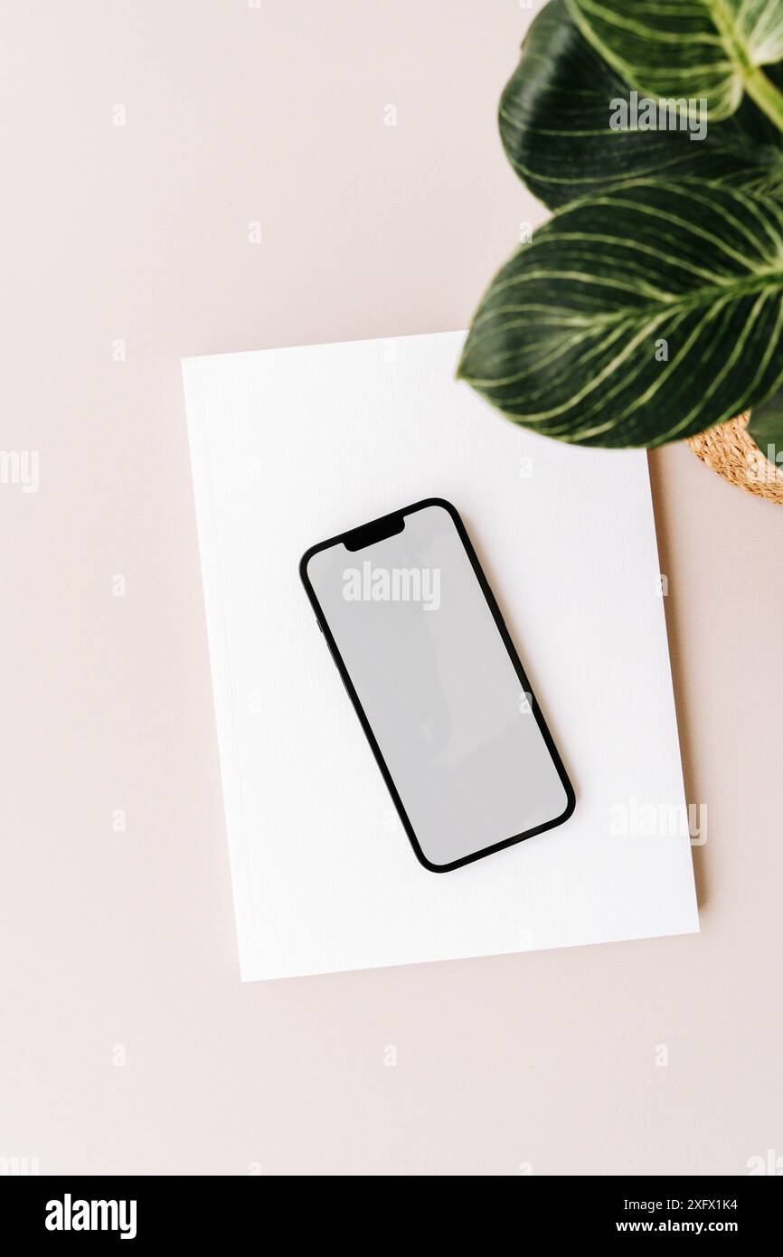 Blank path screen mobile phone with mockup on white magazine on beige ...