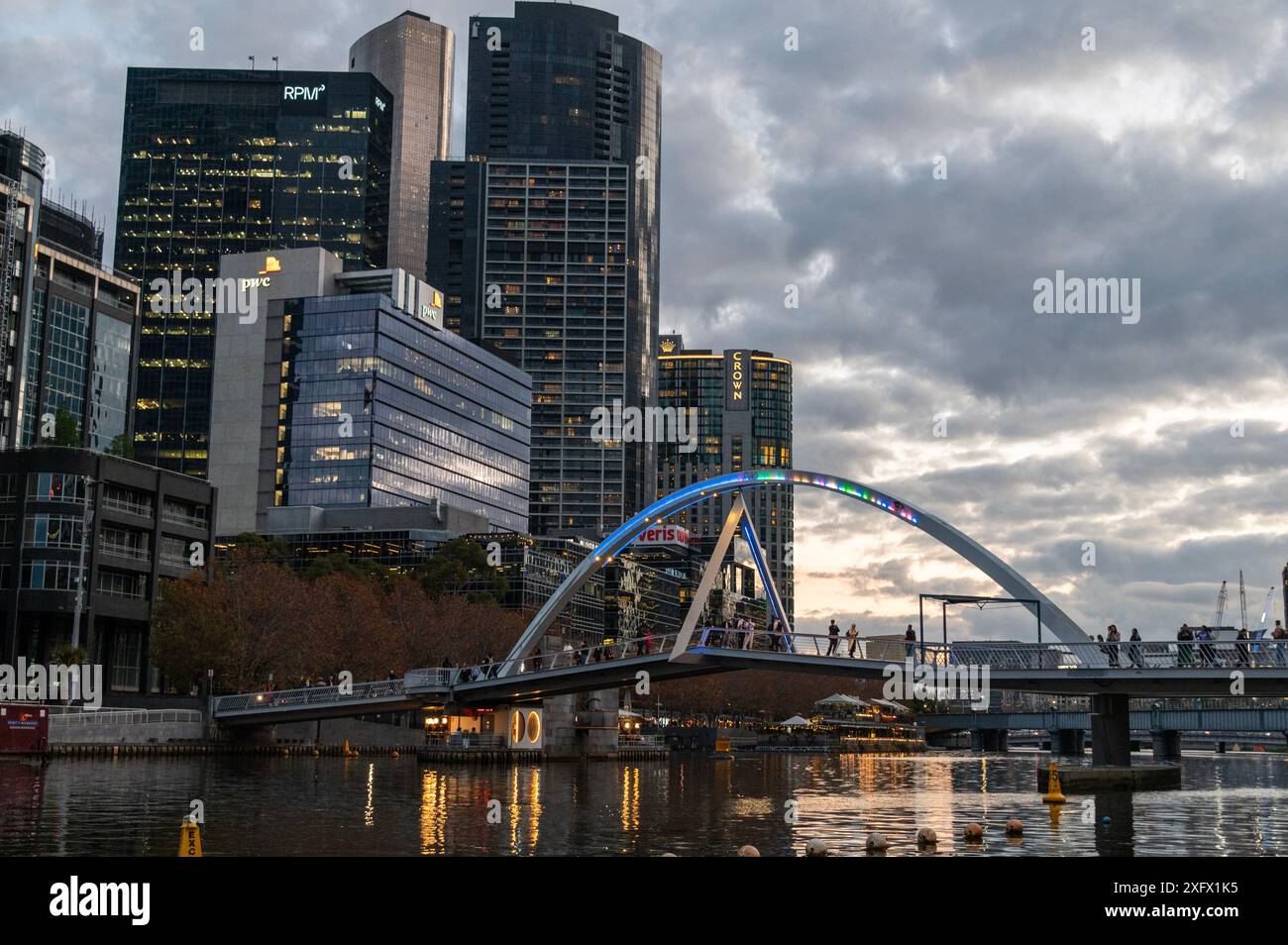 At dusk, city workers criss-cross the pedestrian and cycle path on ...