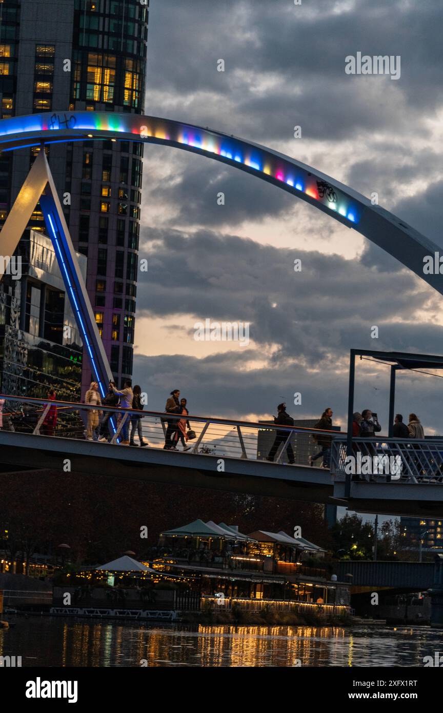 At dusk, city workers criss-cross the pedestrian and cycle path on ...