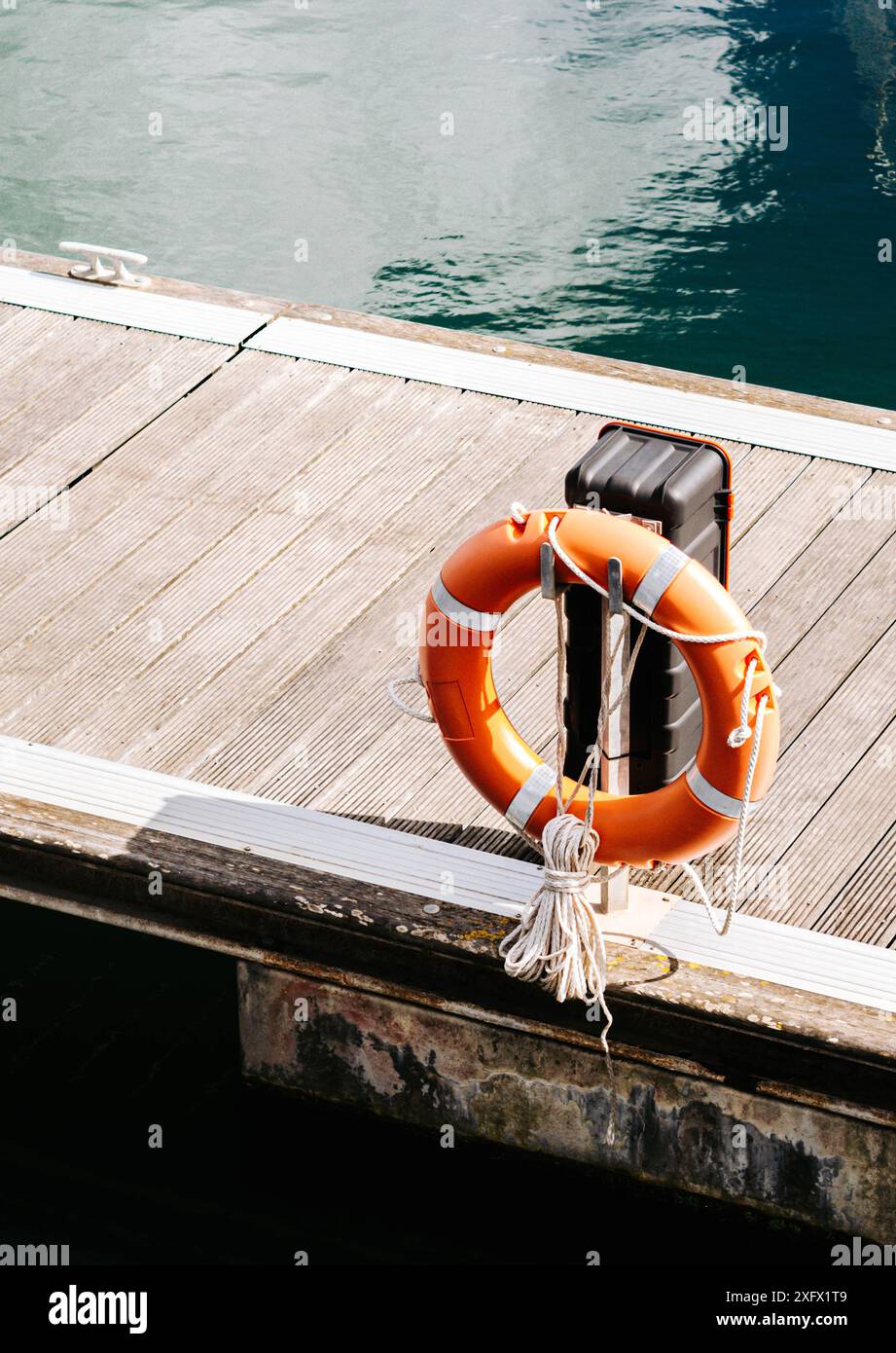 Lifebuoy in the marina. Life safety ring of a red buoy on a pole on the ...