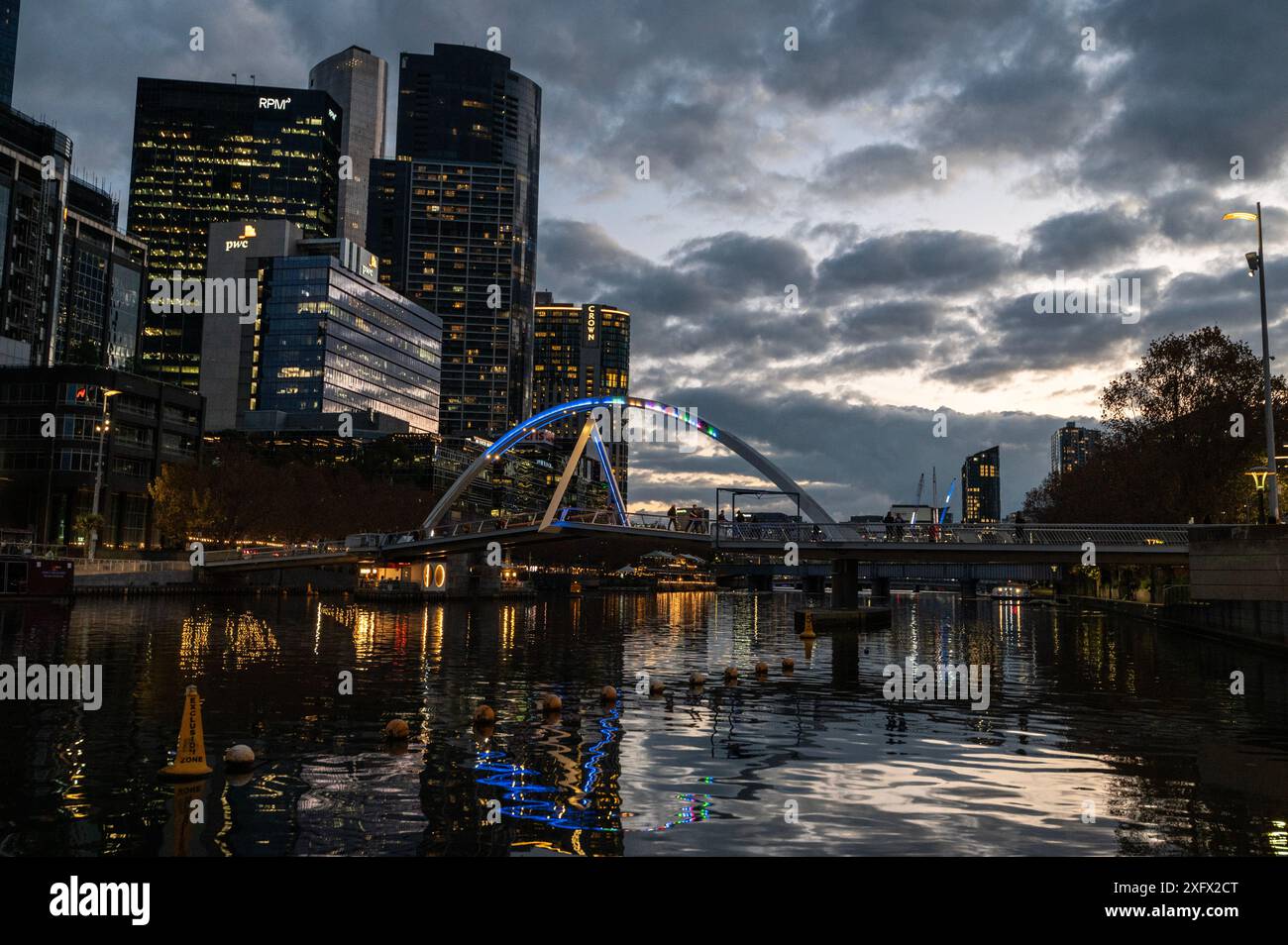 At dusk, city workers criss-cross the pedestrian and cycle path on ...