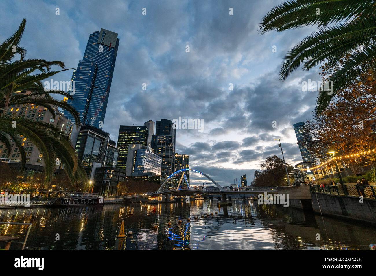 At dusk, city workers criss-cross the pedestrian and cycle path on ...