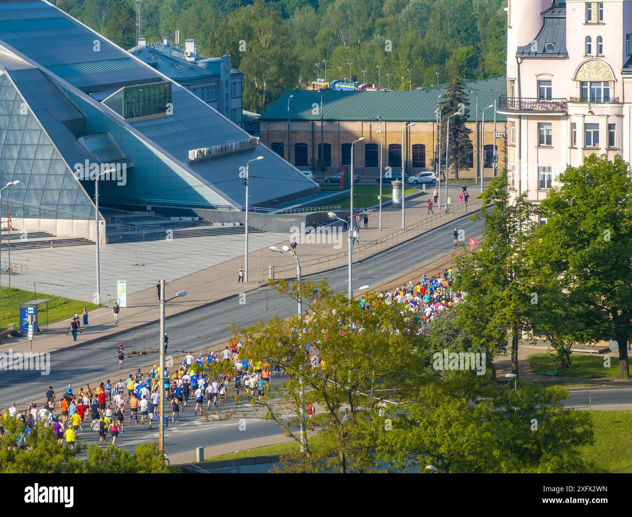 Aerial View of Marathon Runners in Riga with Modern Landmark Building ...