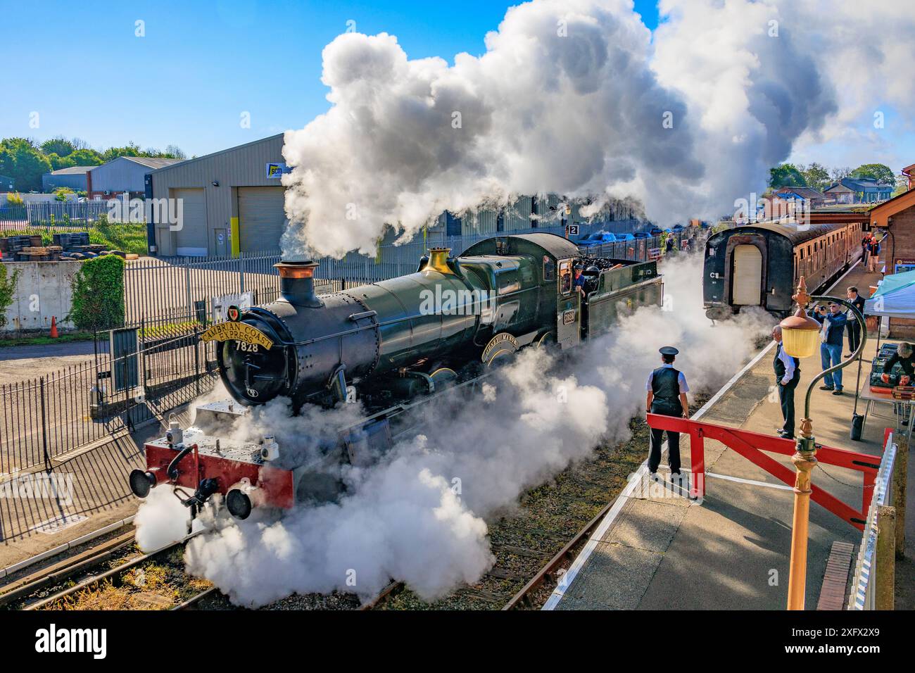 Preserved ex-GWR steam loco 7828 'Odney Manor' steams through Bishops Lydeard station at speed ...
