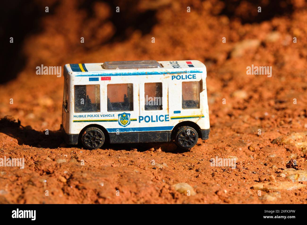 A muddy toy model mobile police vehicle or van on rough terrain Stock ...