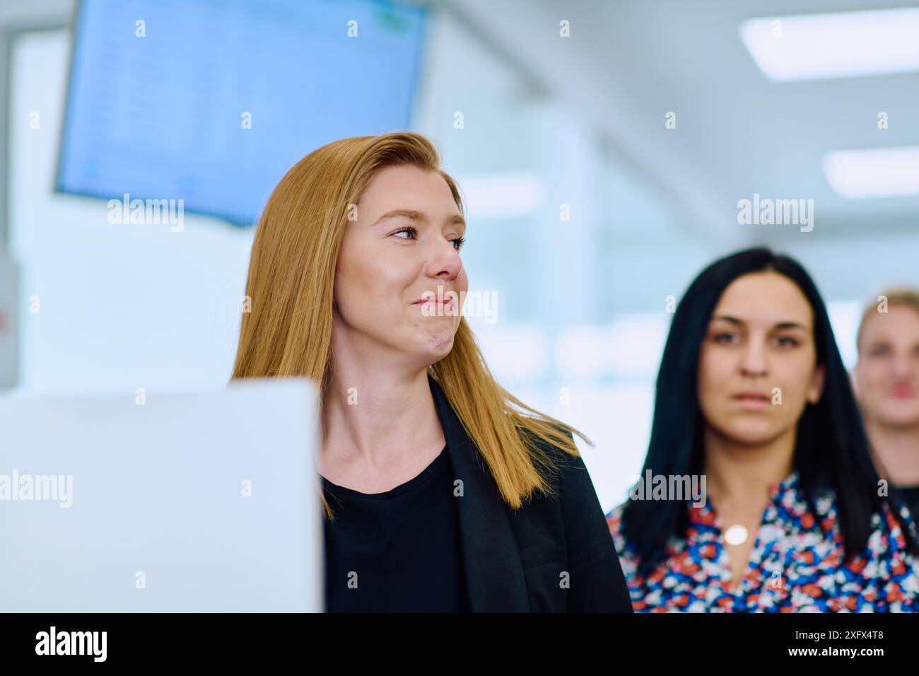 Confident businesswomen stride through the office hallway, deep in ...
