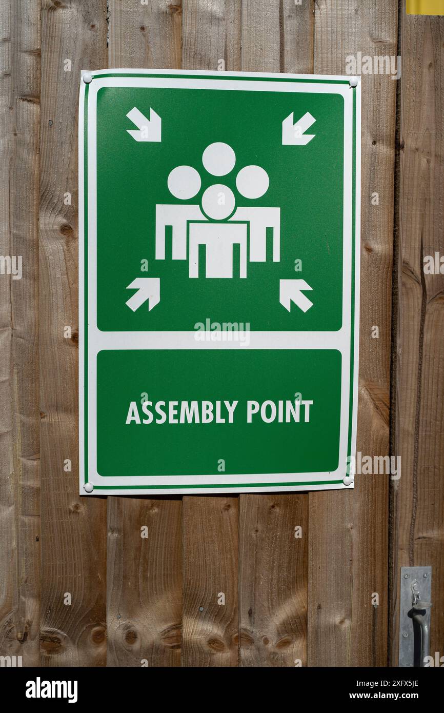 Green white assembly point sign hi-res stock photography and images - Alamy