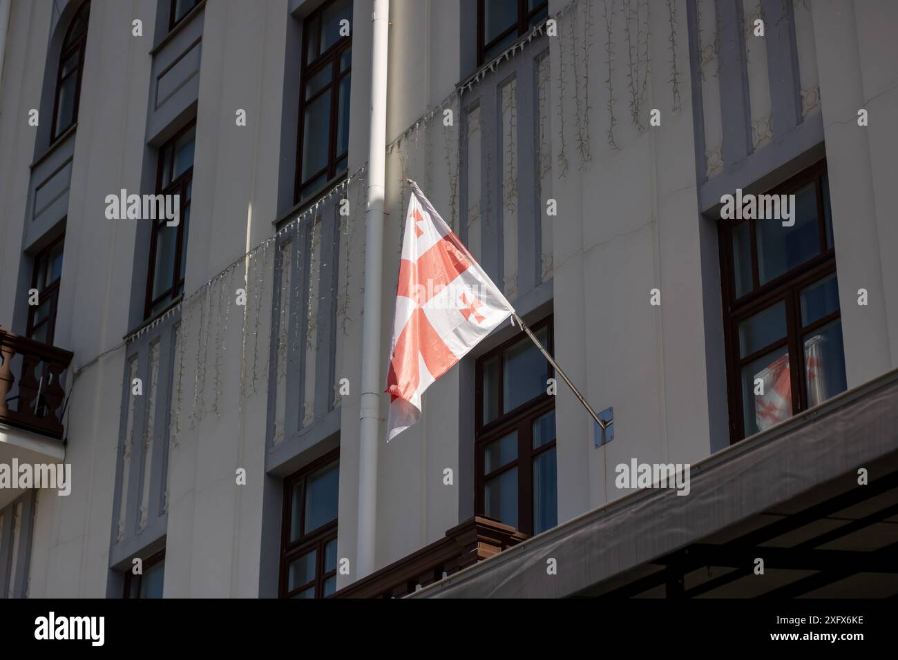 The flag of Georgia is red, white, and blue with a cross on it. It is a ...