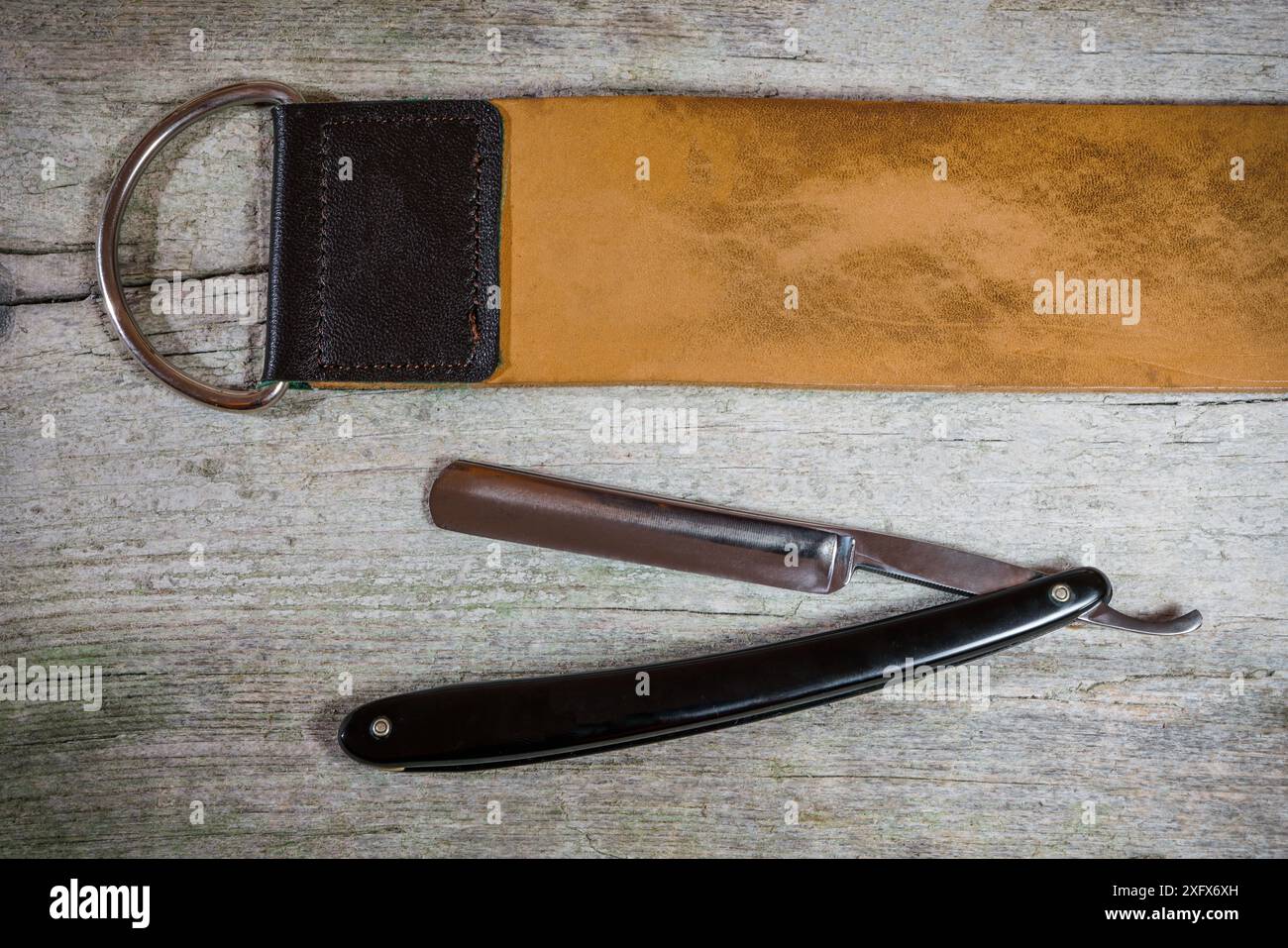 Horizontal close-up photo of vintage straight razor with black scales ...