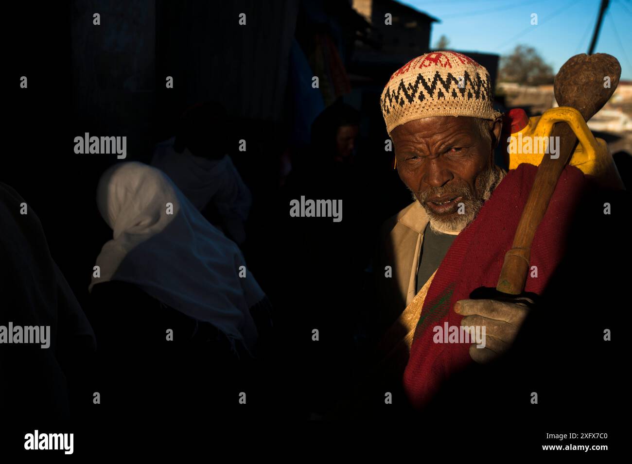 Man carrying plastic container on a stick, Gate of Asmadin, City of ...