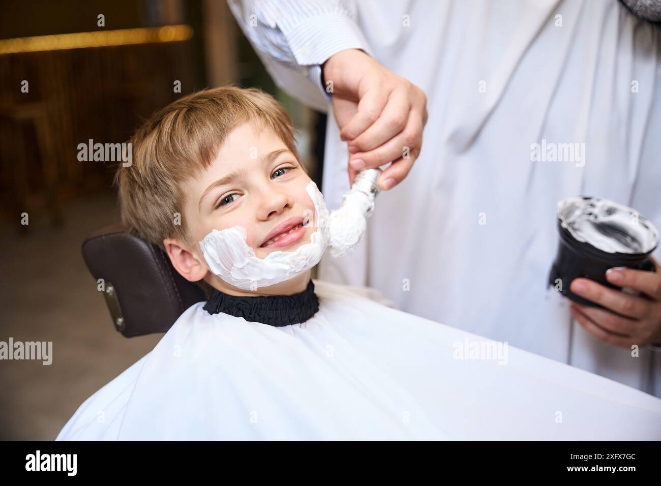 Professional groomer using shaving brush to apply shaving cream Stock ...