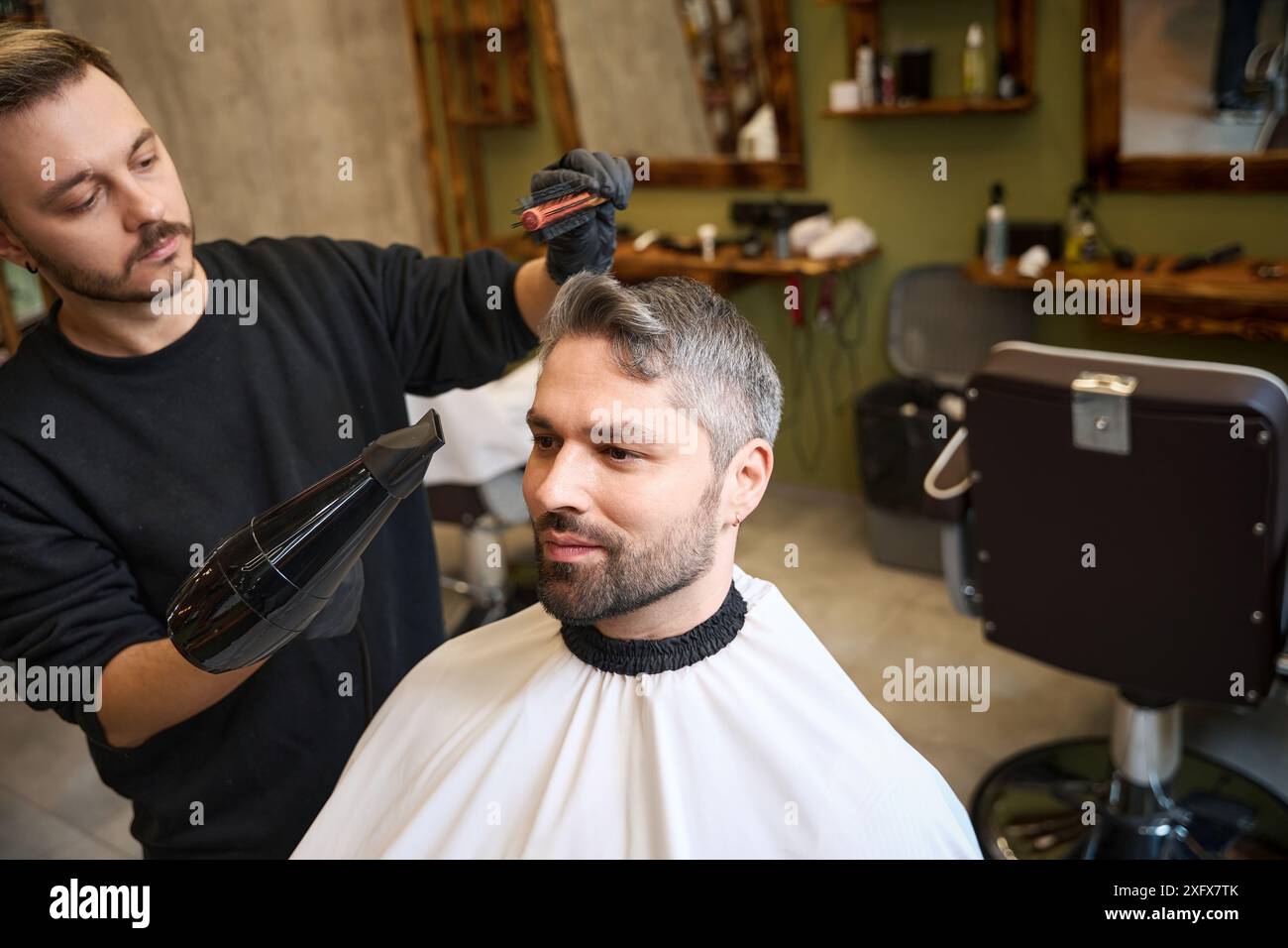 Hair stylist modelling handsome adult man forelock Stock Photo - Alamy