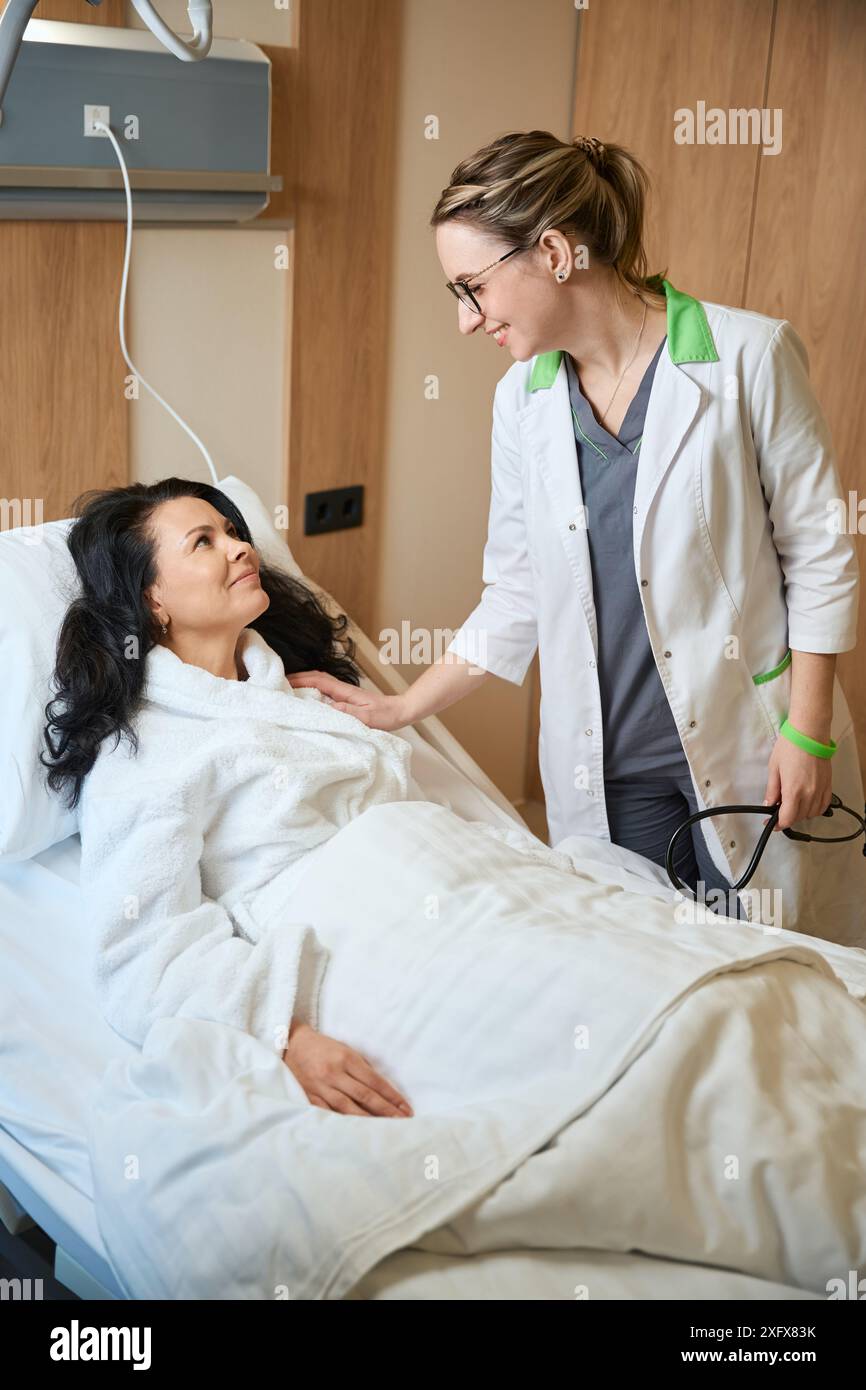 Clinic employee communicates with a patient in the ward Stock Photo - Alamy