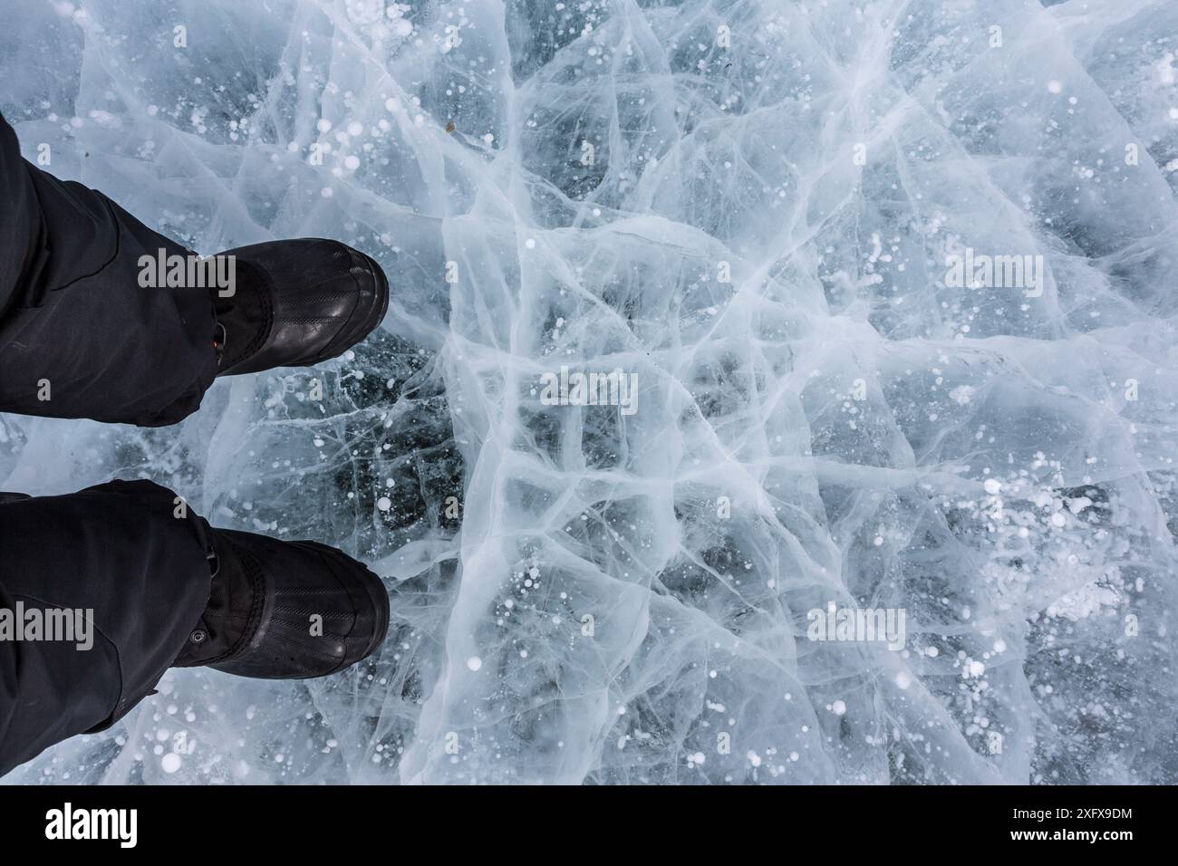 Photographer Sue Flood's feet standing on sea ice near Elephant Head ...