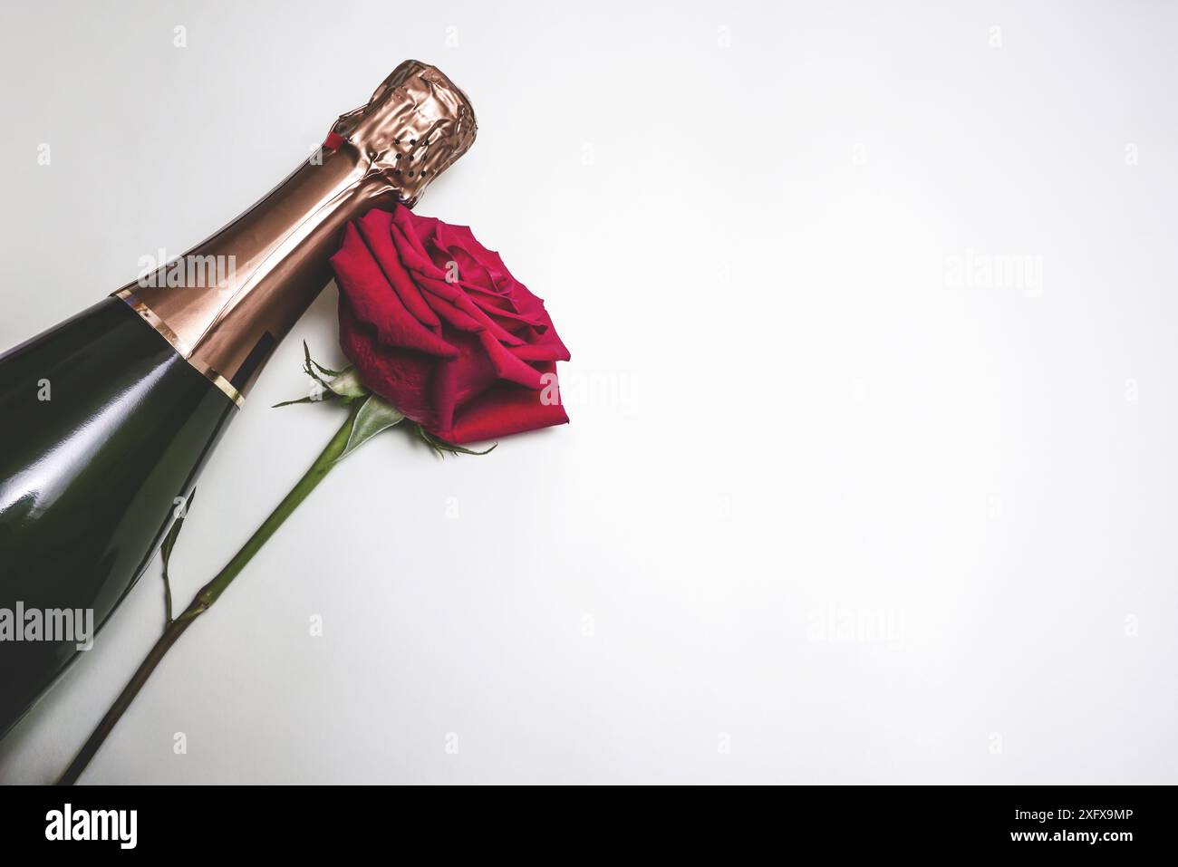 Horizontal photo of festive valentines day with bottle of champagne and ...