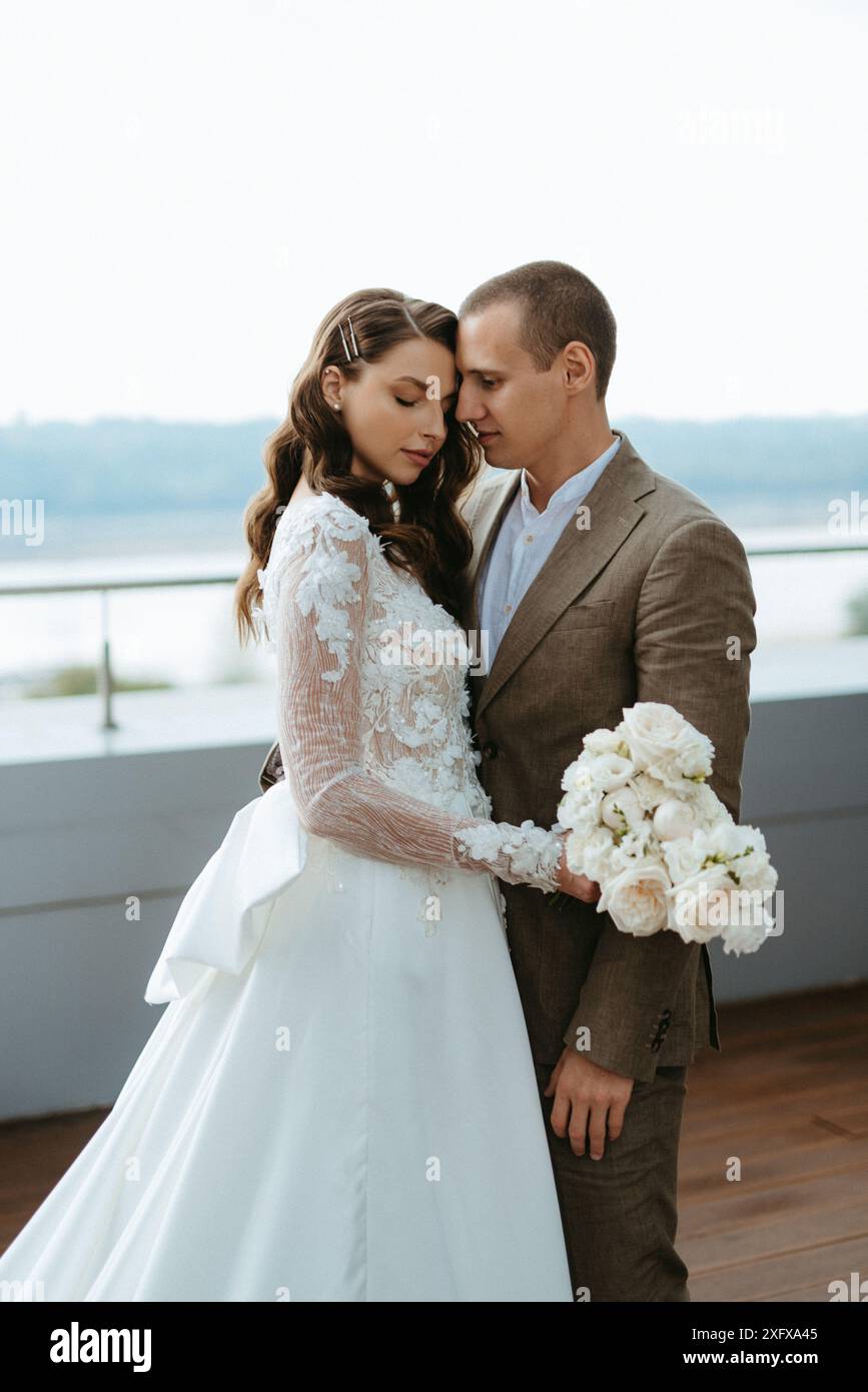 bride and groom first meeting on the roof of a glass skyscraper Stock ...