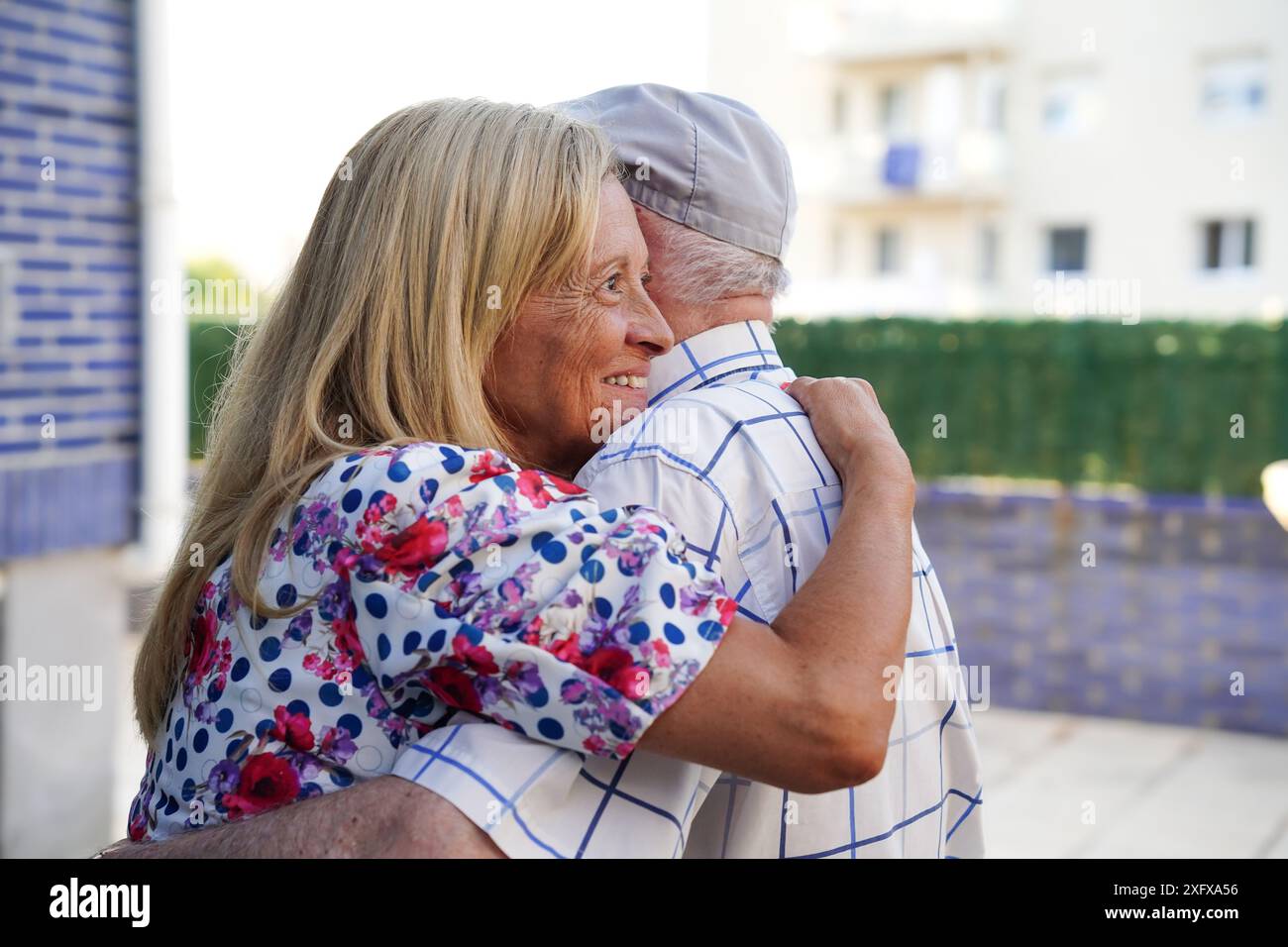 A family hug each other. A father and his daughter hugging on the ...