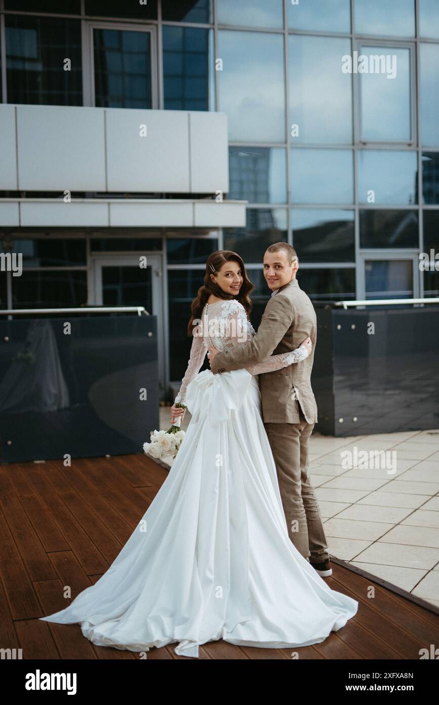 bride and groom first meeting on the roof of a glass skyscraper Stock ...
