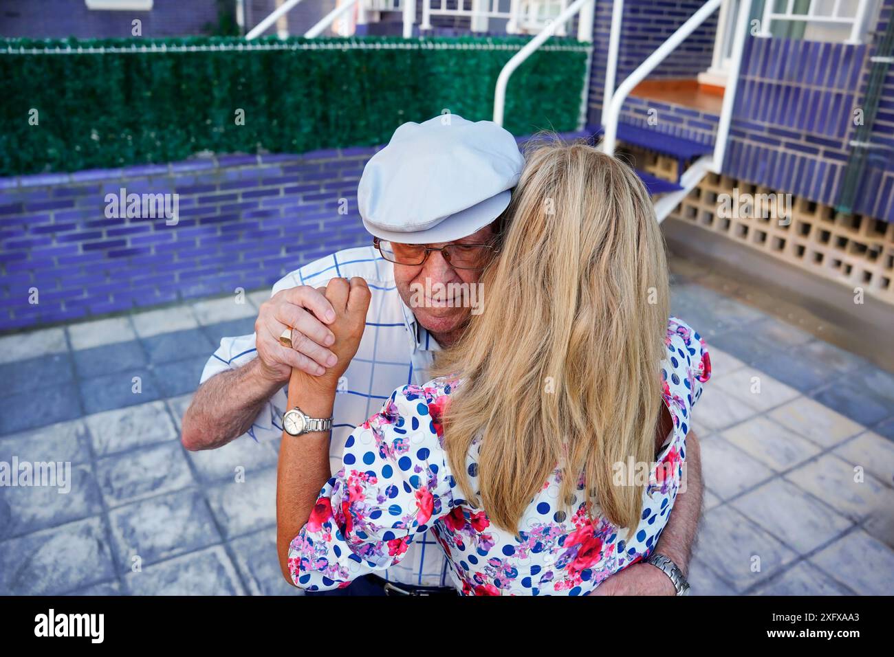 Aerial view of a daughter and her older father dancing together. Active ...