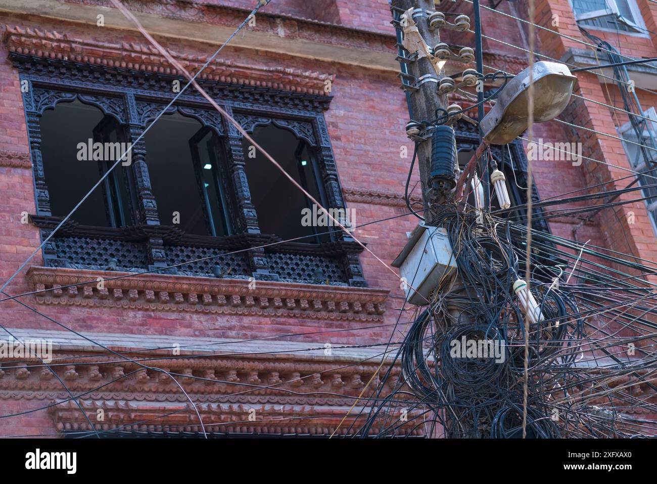 Cables and telegraph pole with building in background, Kathmandu City ...
