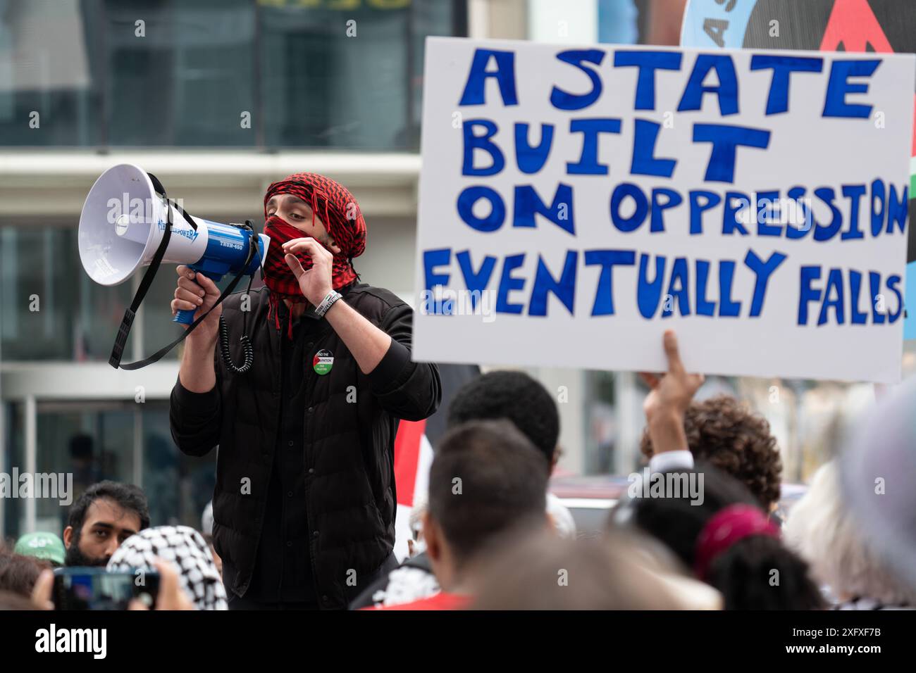 Protesters marching with picket signs at a Gaza protest in the streets ...