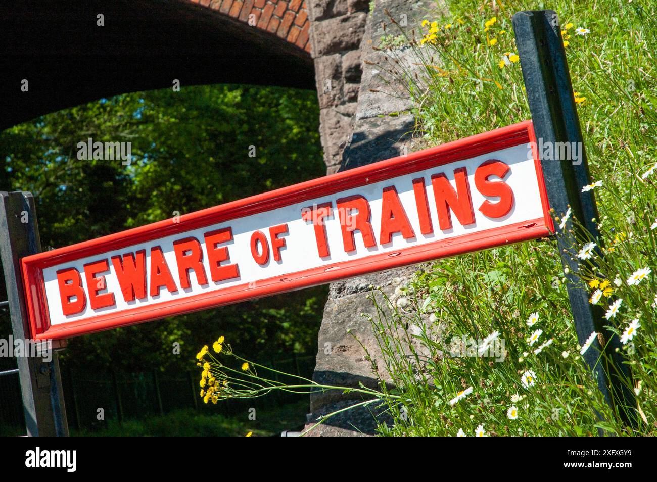 Beware of Trains sign Stock Photo - Alamy