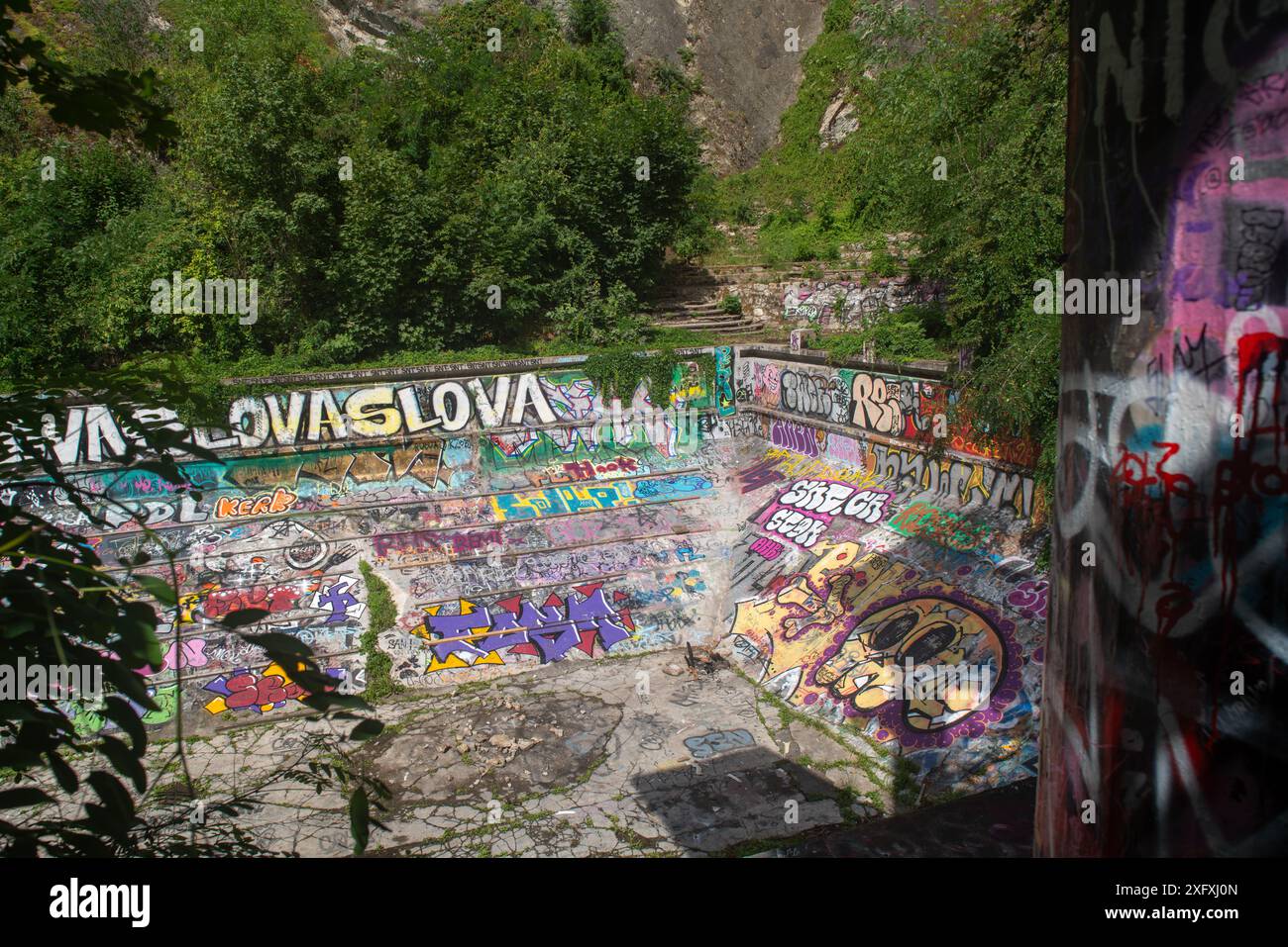 Graffiti-covered remains of swimming pool from 1920s in the complex of ...