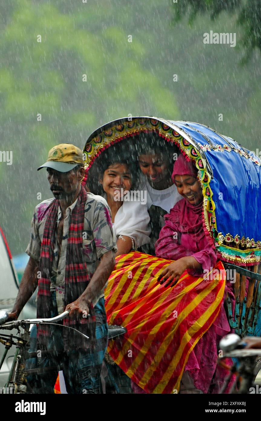 People make their way through heavy shower on the Bangla month of Ashar ...