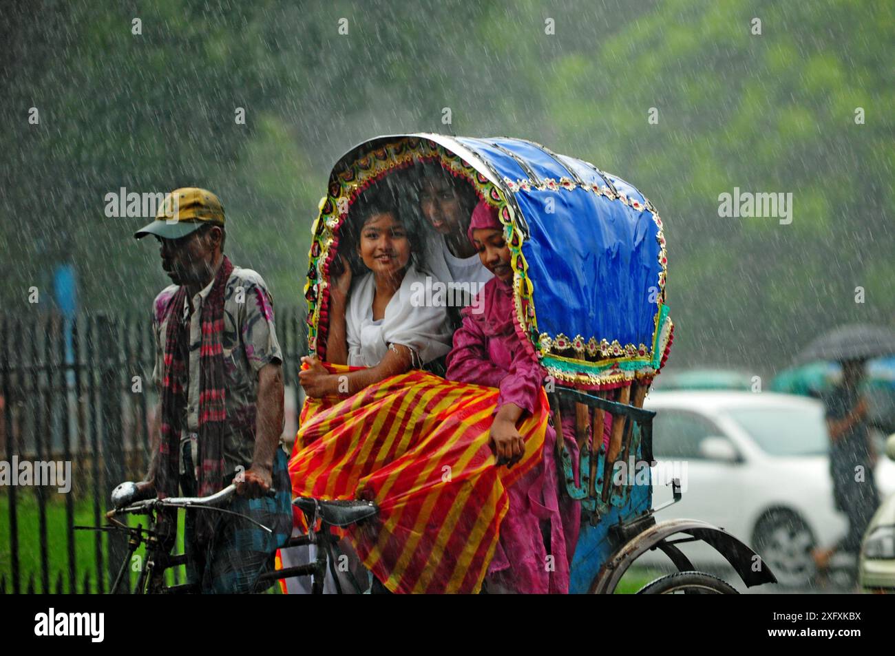 People make their way through heavy shower on the Bangla month of Ashar ...