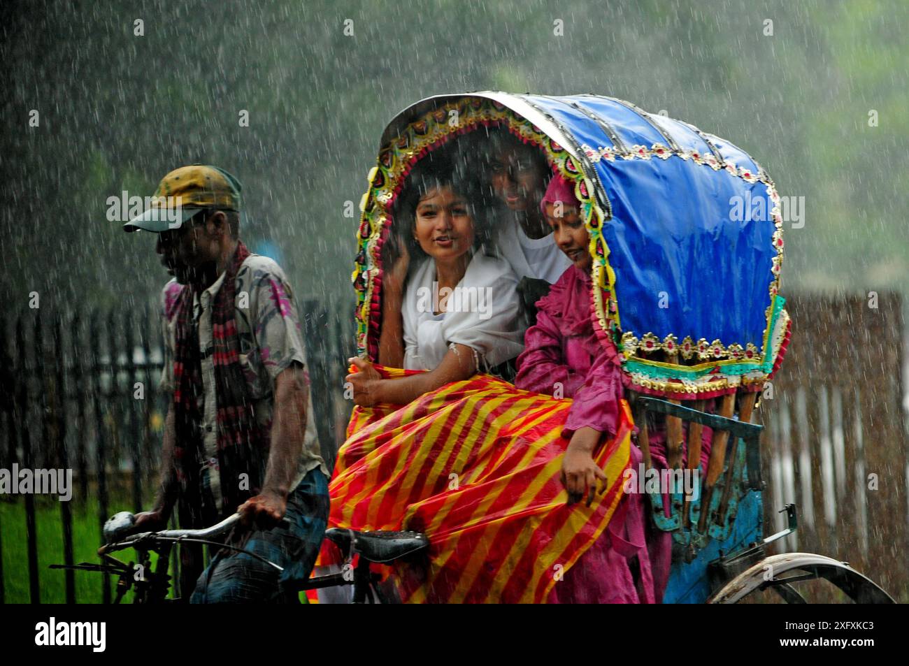 People make their way through heavy shower on the Bangla month of Ashar ...