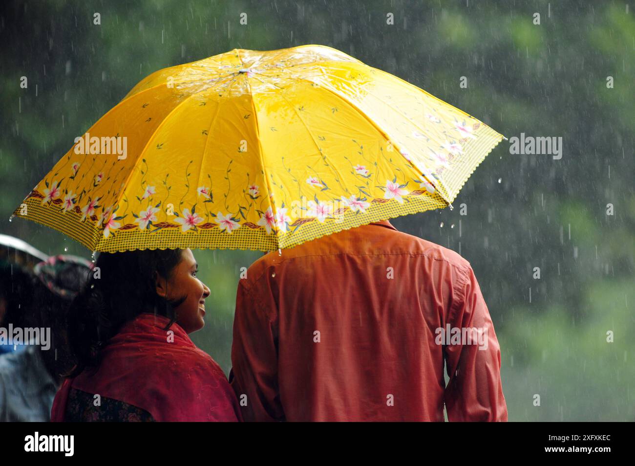 People make their way through heavy shower on the Bangla month of Ashar ...