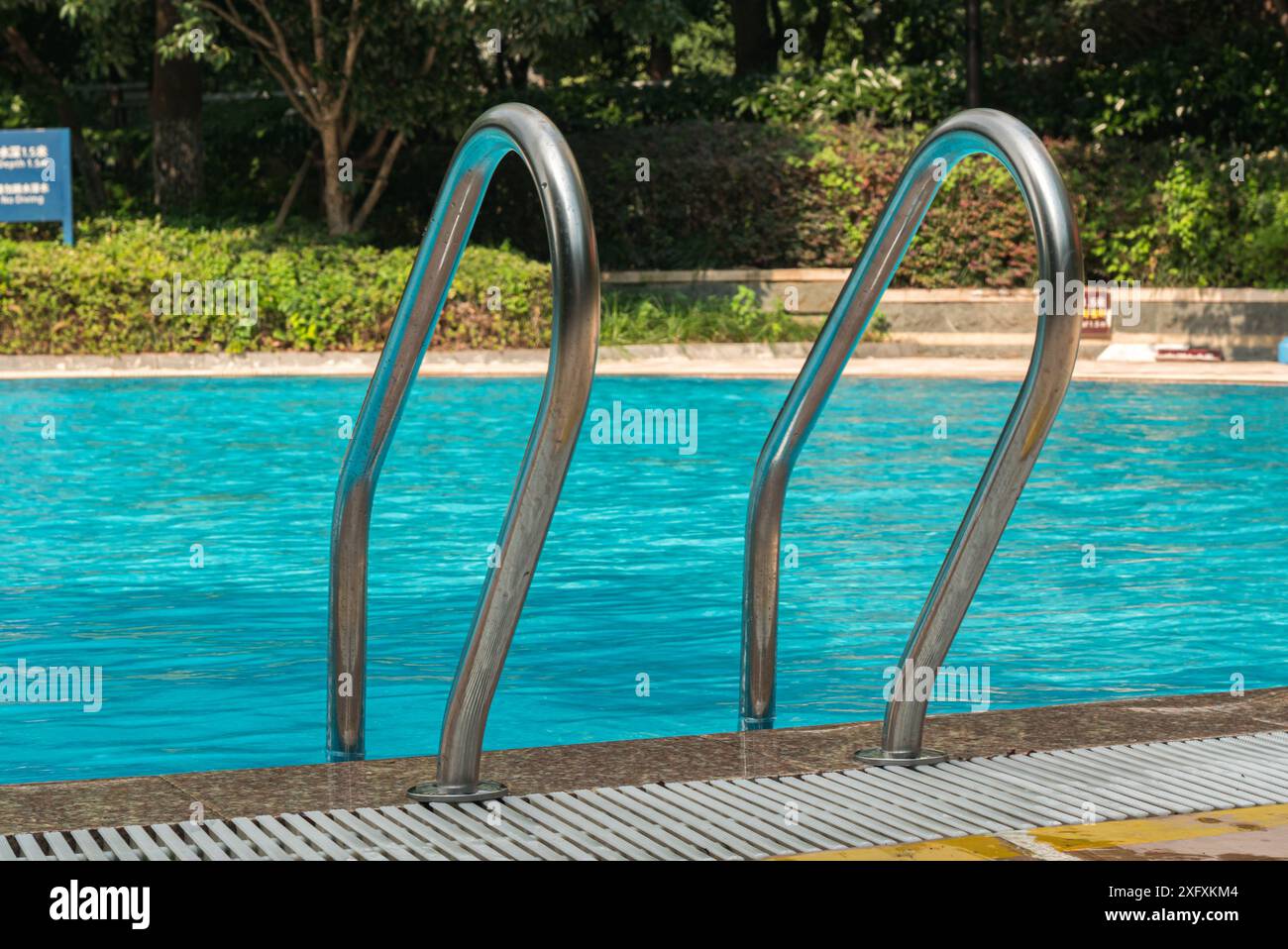 A close-up view of the stainless steel handrails of a swimming pool ...