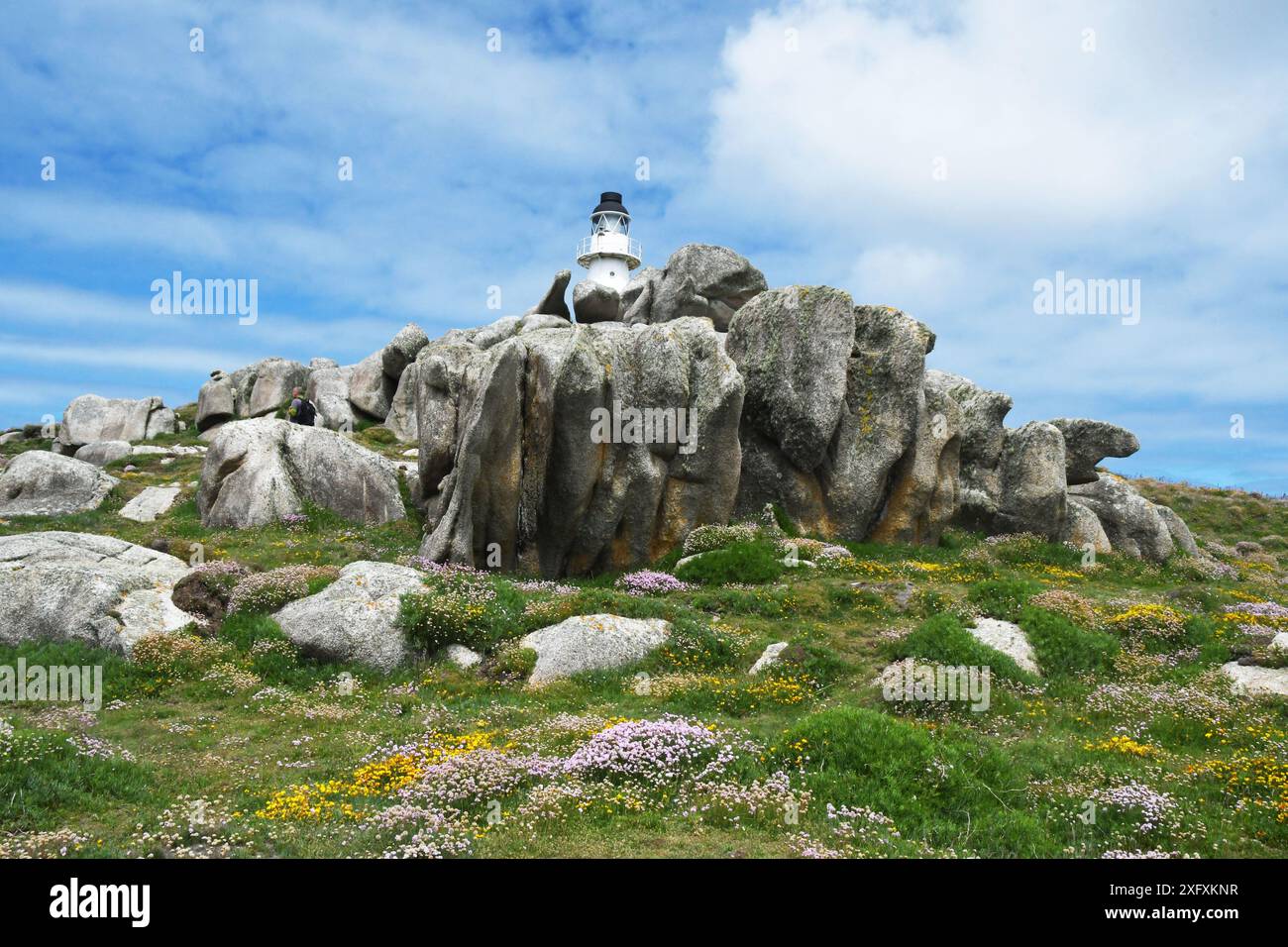 The penninis head lighthouse above the wind,rain and sea erored granite ...