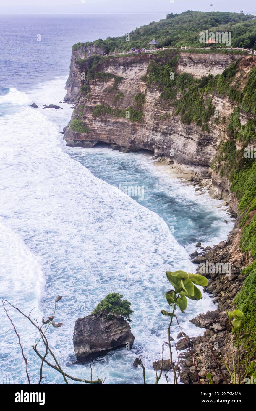 Vertical photo of cliff by the ocean on a cloudy day with water, clouds ...