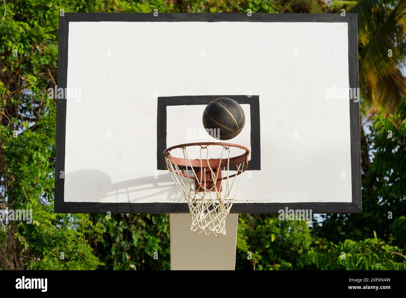 Basketball, black ball going through hoop. Outdoors Stock Photo - Alamy