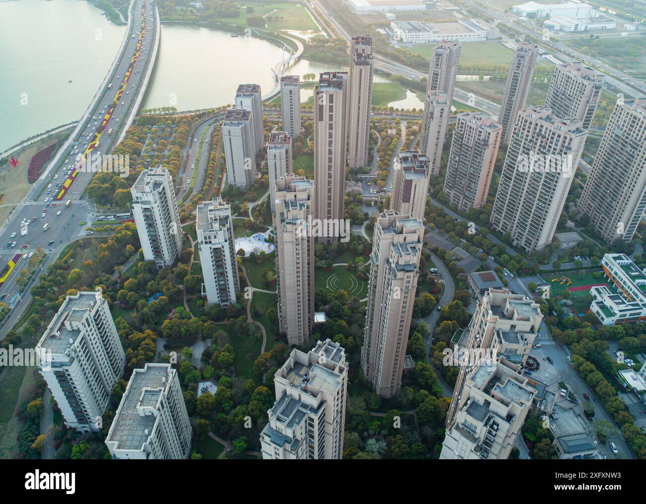 An aerial view of a modern city skyline at sunset, showcasing numerous ...