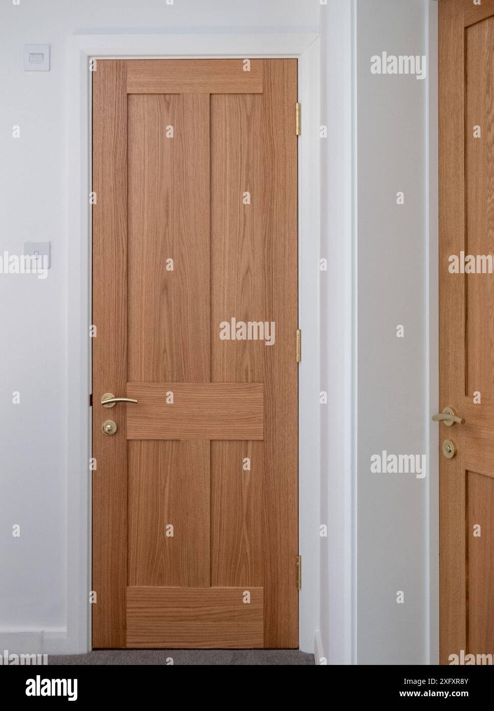 Wooden, shaker style, panelled internal doors with brass door furniture ...