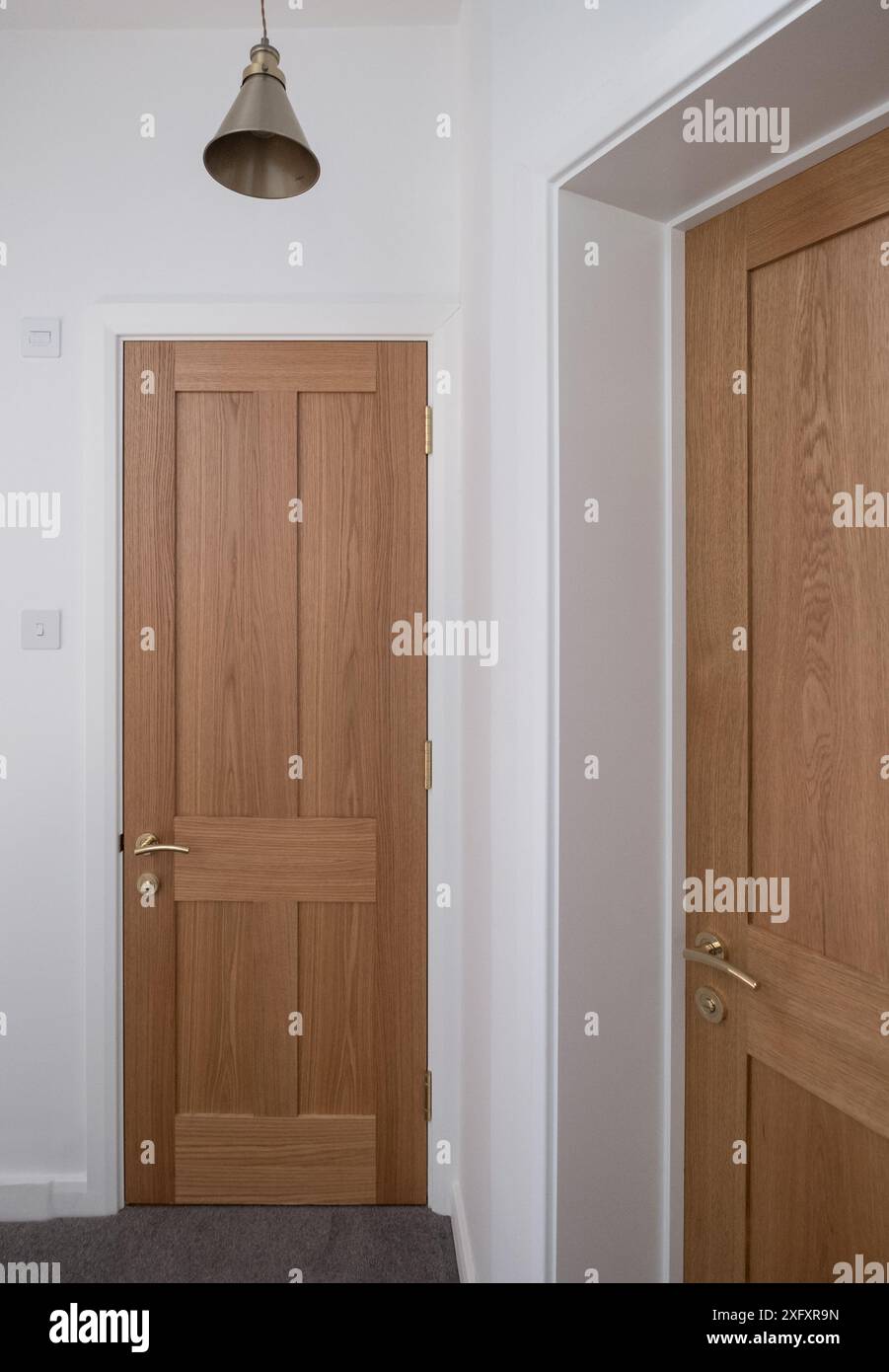 Wooden, shaker style, panelled internal doors with brass door furniture ...