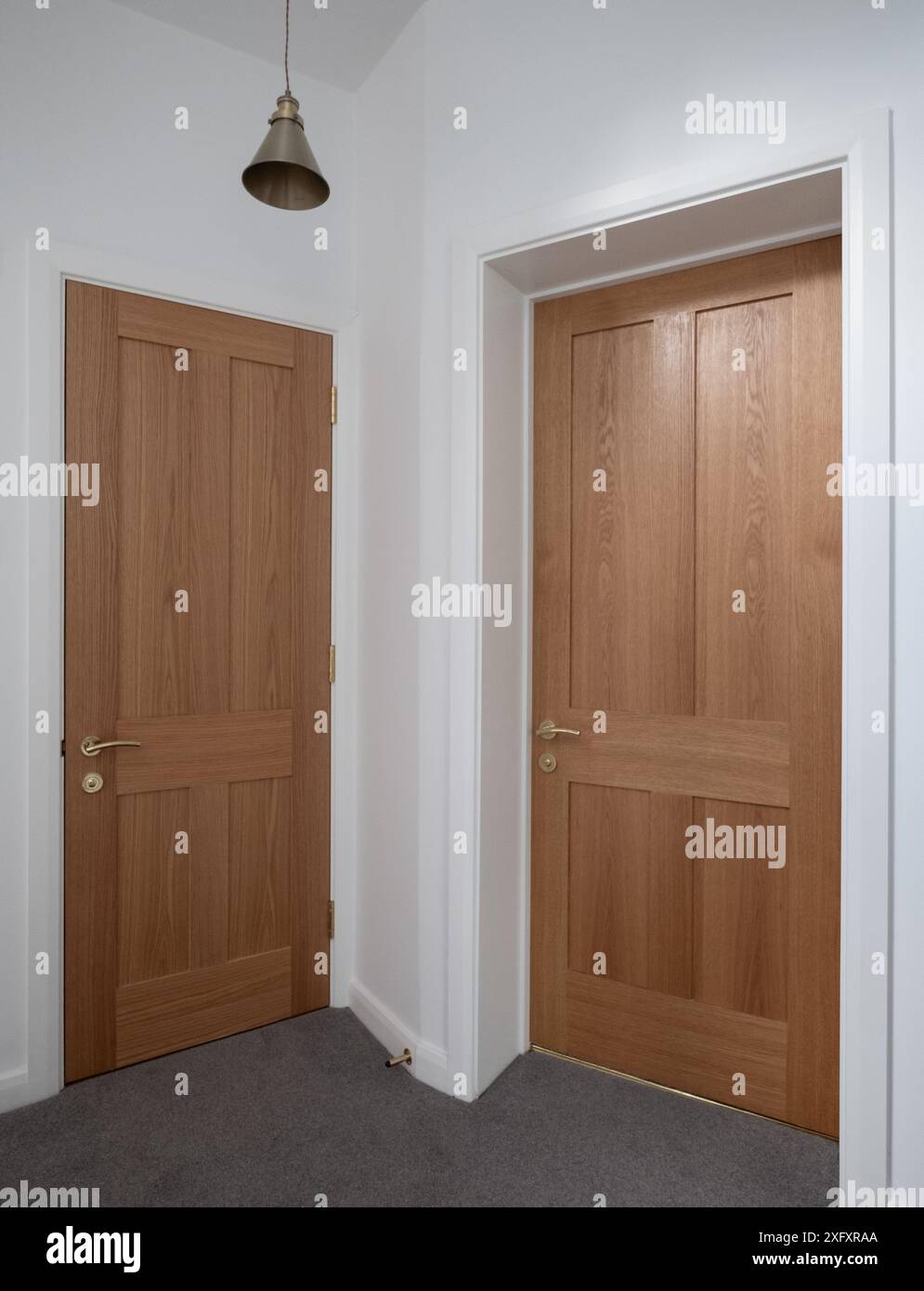 Wooden, shaker style, panelled internal doors with brass door furniture ...