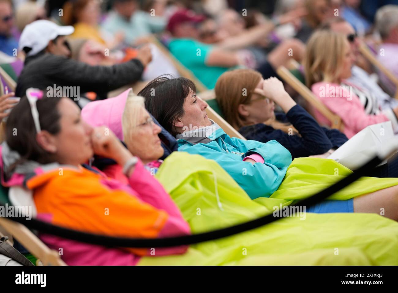 Fans watch the third round matches on a large screen from the "Hill" at ...