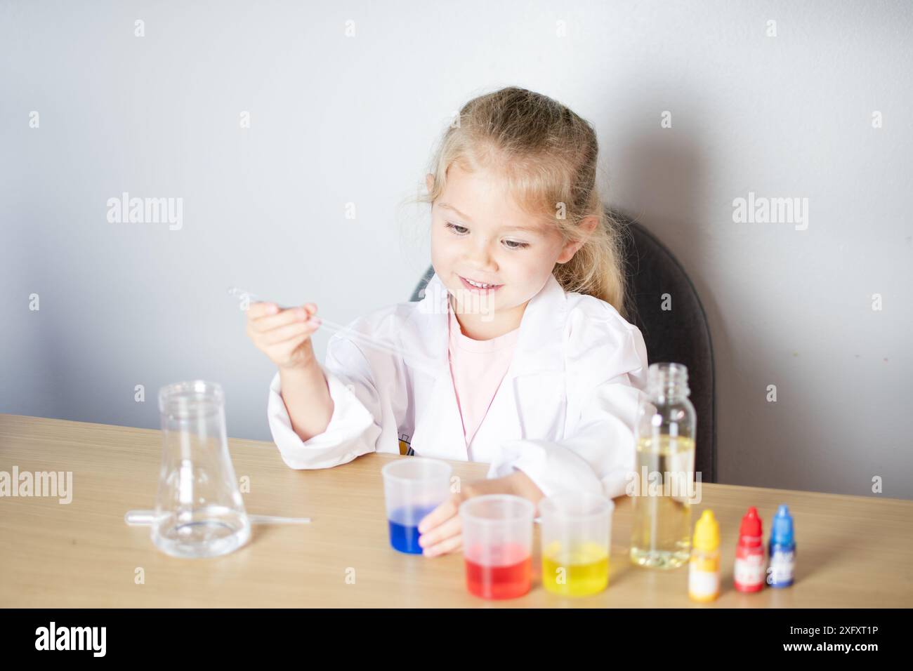 Little girl doing science experiment. Kindergarten. Education concept ...