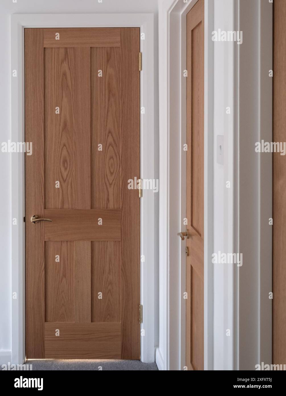 Wooden, shaker style, panelled internal doors with brass door furniture ...