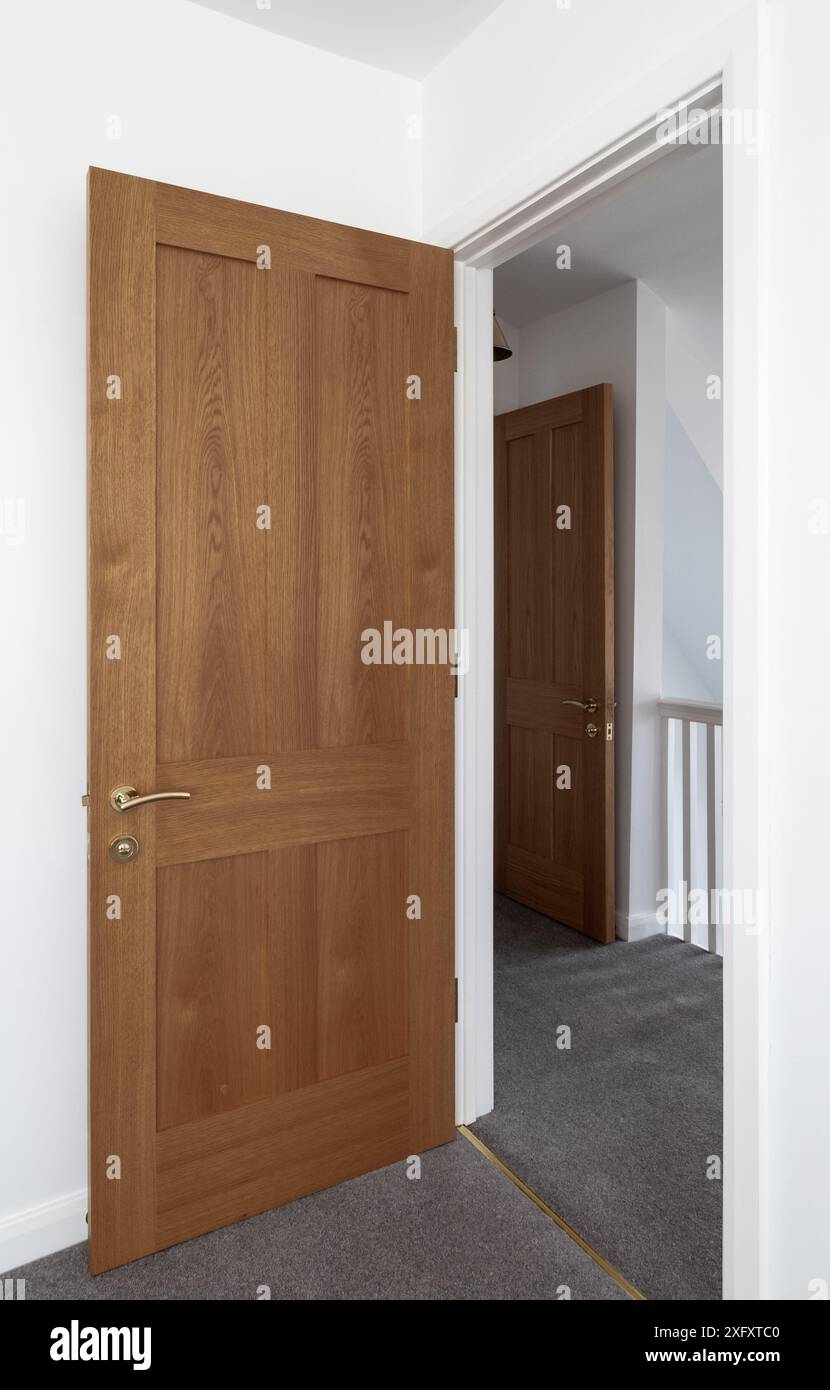 Wooden, shaker style, panelled internal doors with brass door furniture ...
