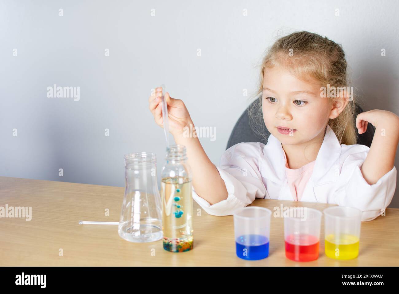 Little girl doing science experiment. Kindergarten. Education concept ...